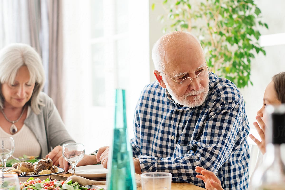 "Family Dining At Home." by Stocksy Contributor "BONNINSTUDIO " - Stocksy