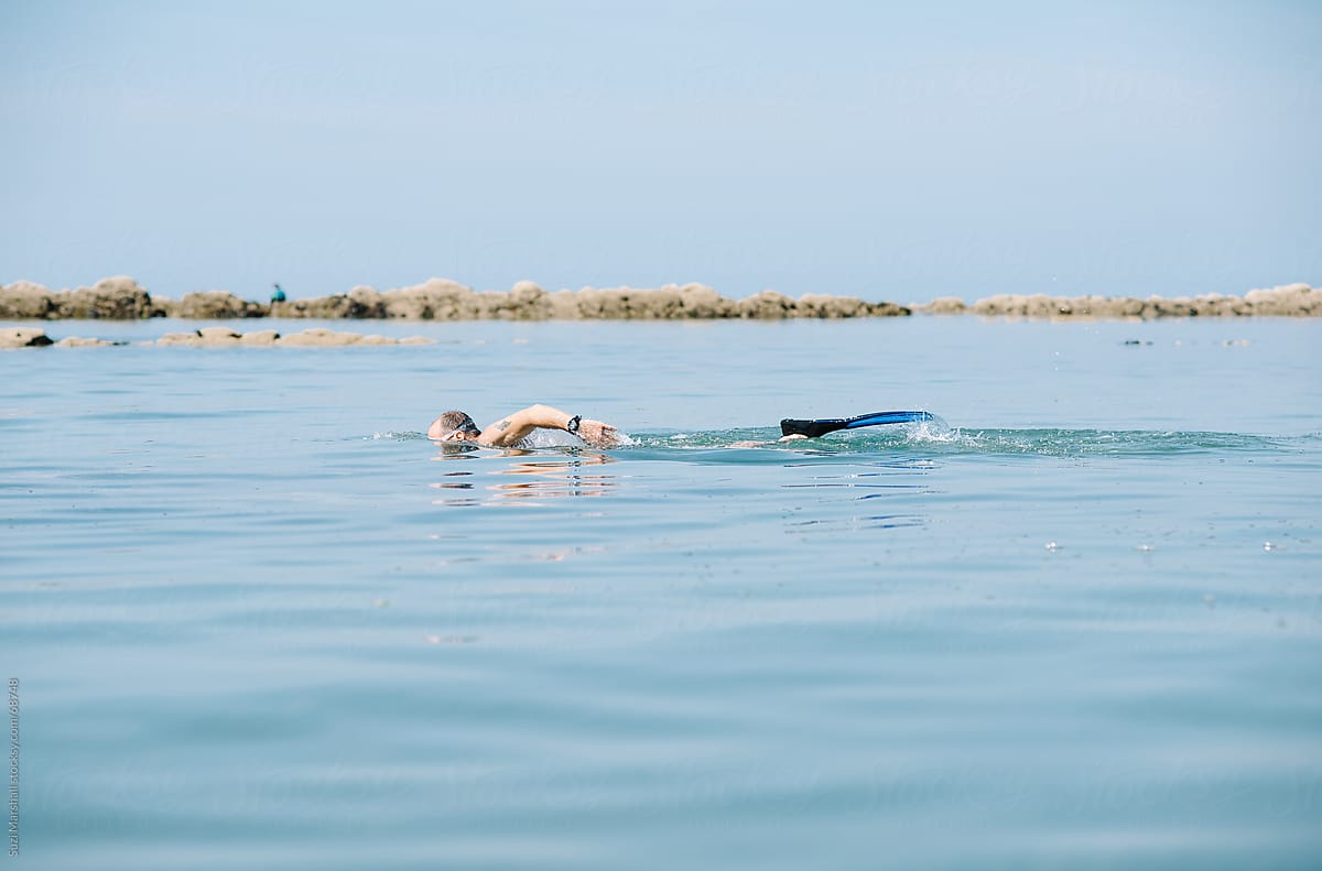 "Man Swimming In The Sea Wearing Goggles And Flippers" by Stocksy ...