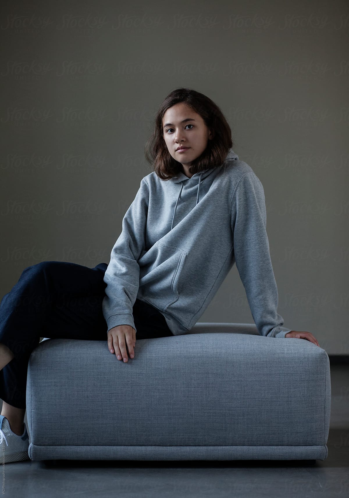 "Portrait Of A Young Woman Sitting On Couch." by Stocksy Contributor ...