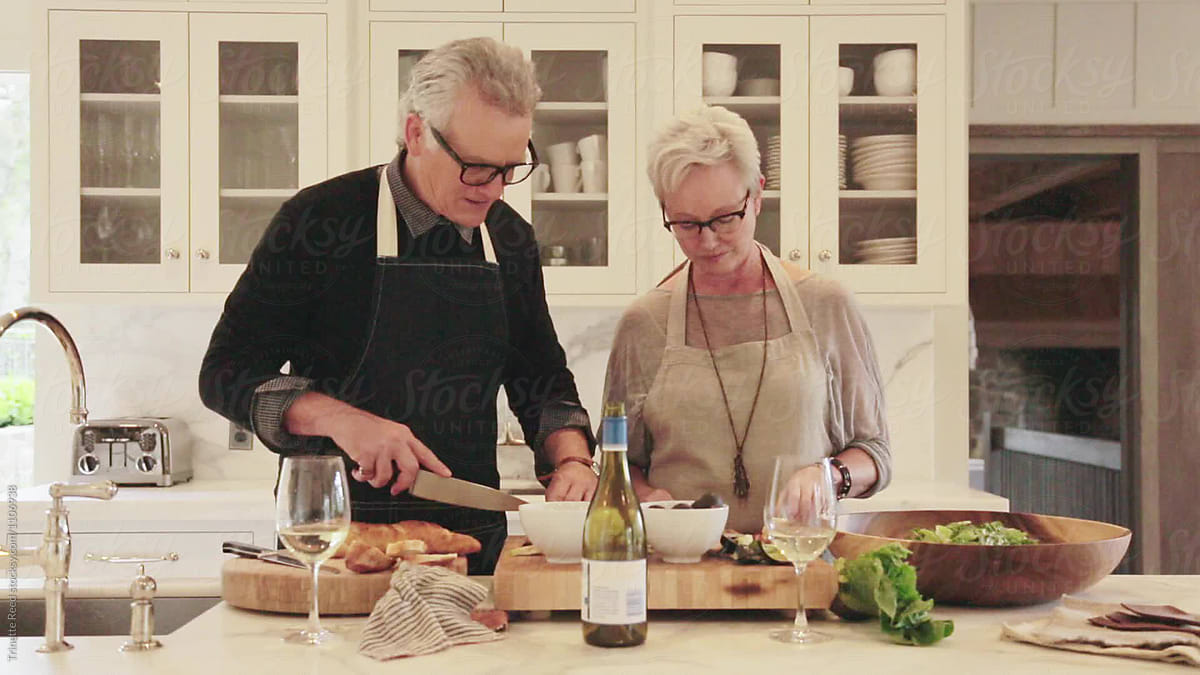 "Senior Couple Cooking And Talking In Kitchen" by Stocksy Contributor ...