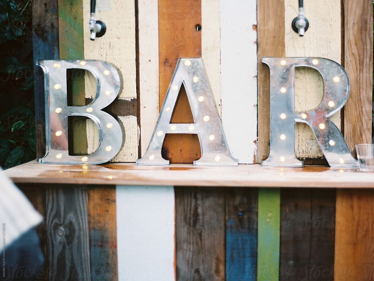 "Lighted Bar Sign On Wood" by Stocksy Contributor "Wendy Laurel" - Stocksy