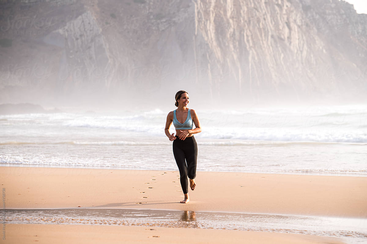 "Woman Running On Coast Near Sea" by Stocksy Contributor "David Prado ...