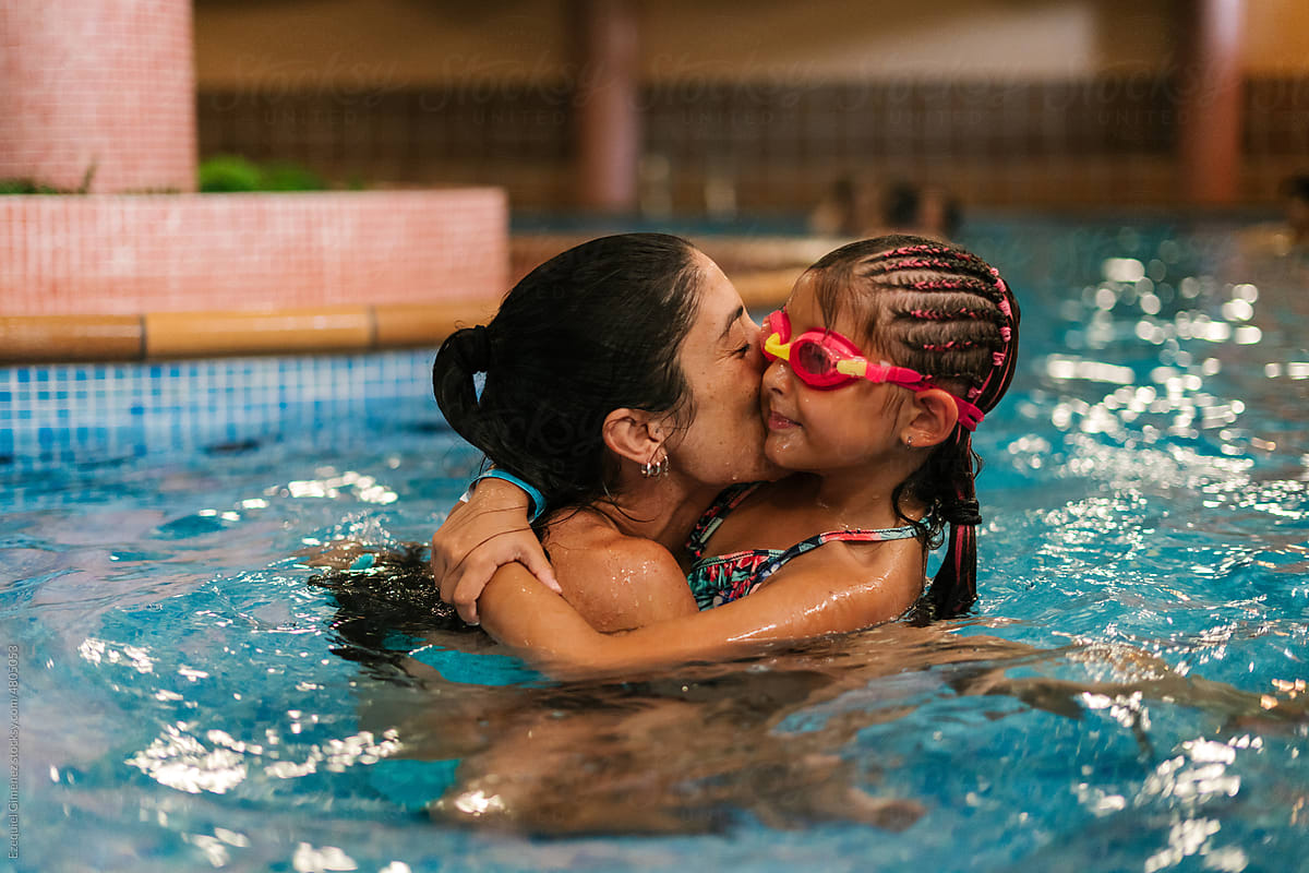 "Hispanic Mother And Daughter Hugging In Swimming Pool" by Stocksy ...