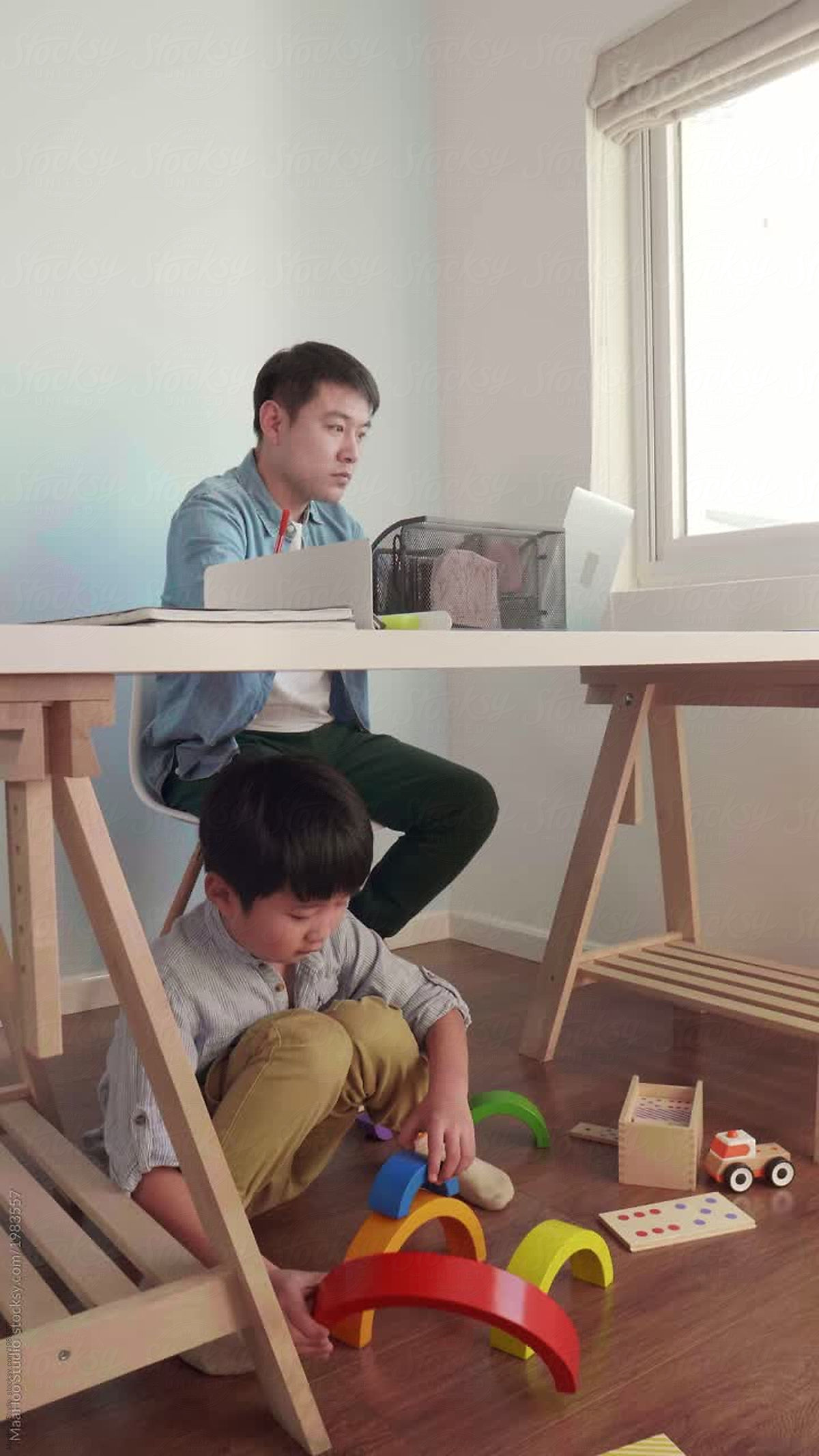 "Father Working At Home" by Stocksy Contributor "MaaHoo" - Stocksy