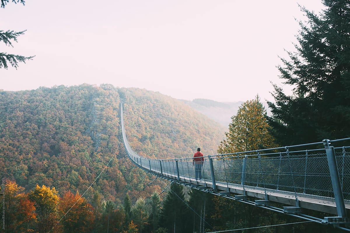 "Man Walking On A Long Bridge In Nature" by Stocksy Contributor "Jovana ...
