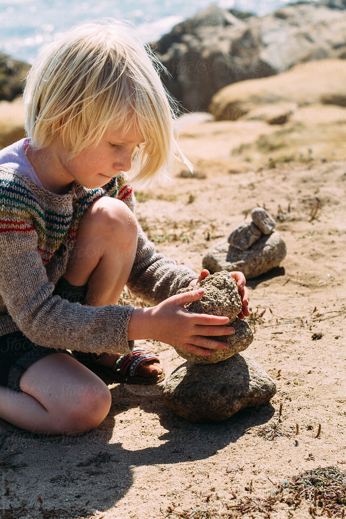 "Child Concentrating On Stacking Stones" by Stocksy Contributor "Jess ...