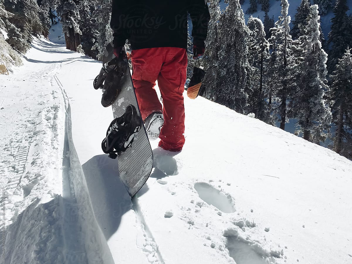 "Snowboarder Hiking In Snow With Board" by Stocksy Contributor "MEGHAN ...