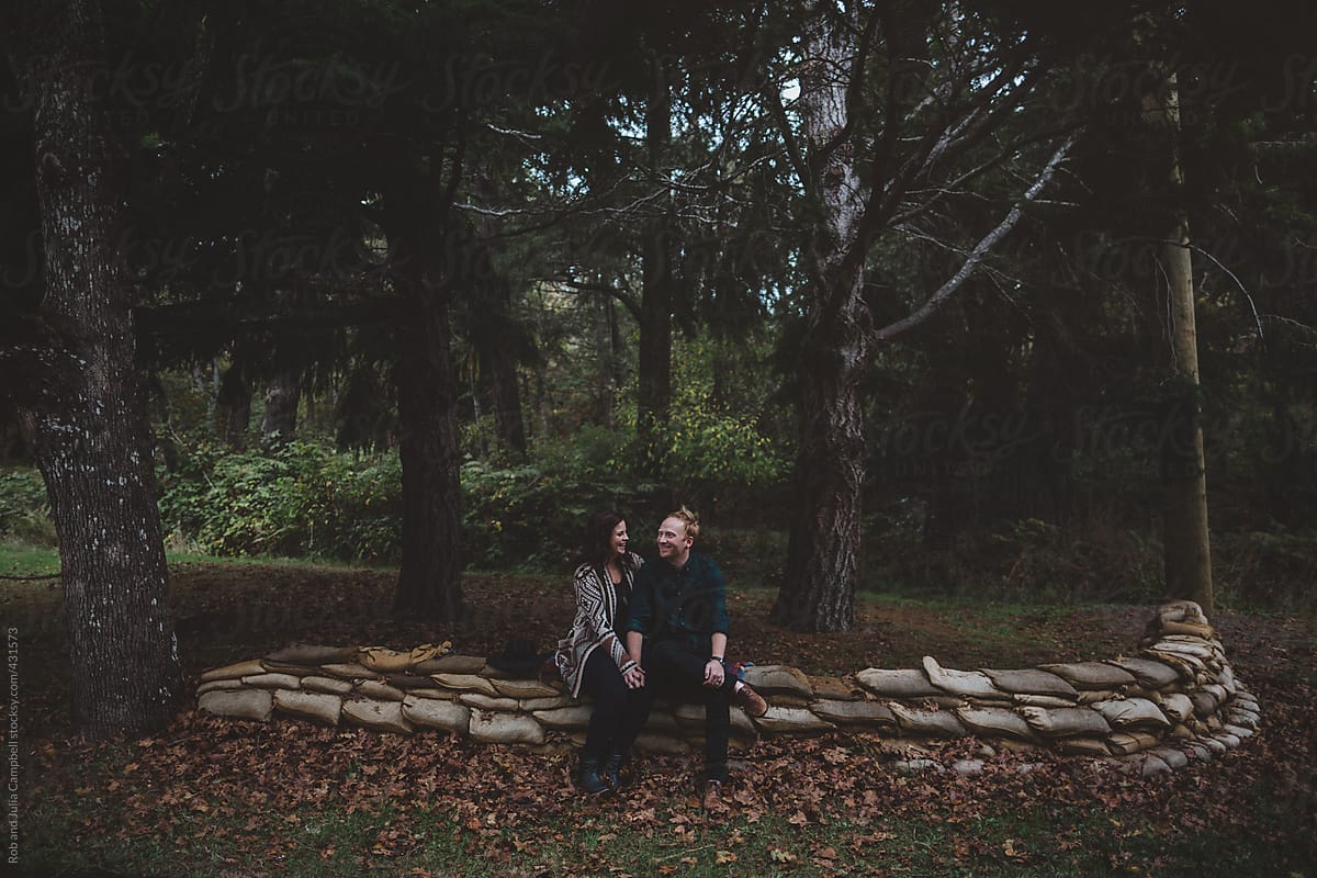 "Young Couple Enjoying Hanging Out Together Outside On Sandbags" by ...