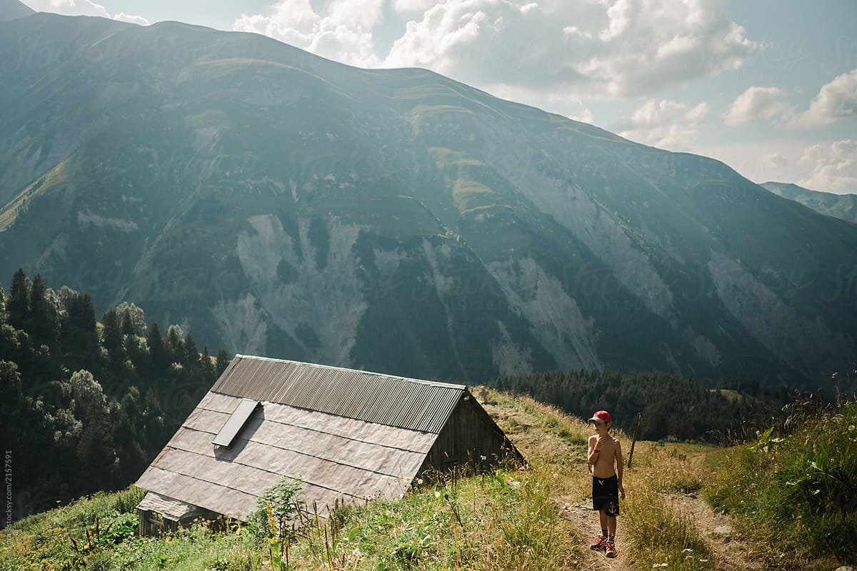 "View Of Mountain Hut In The Alps, Little Boy Running On Path" by ...