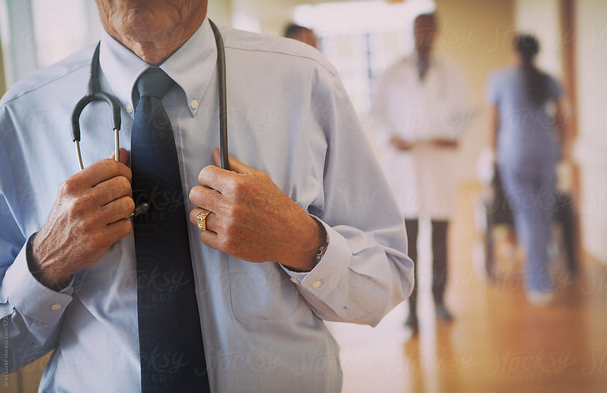 "Hospital: Anonymous Doctor Walking Through Hallway Holding Stethoscope ...