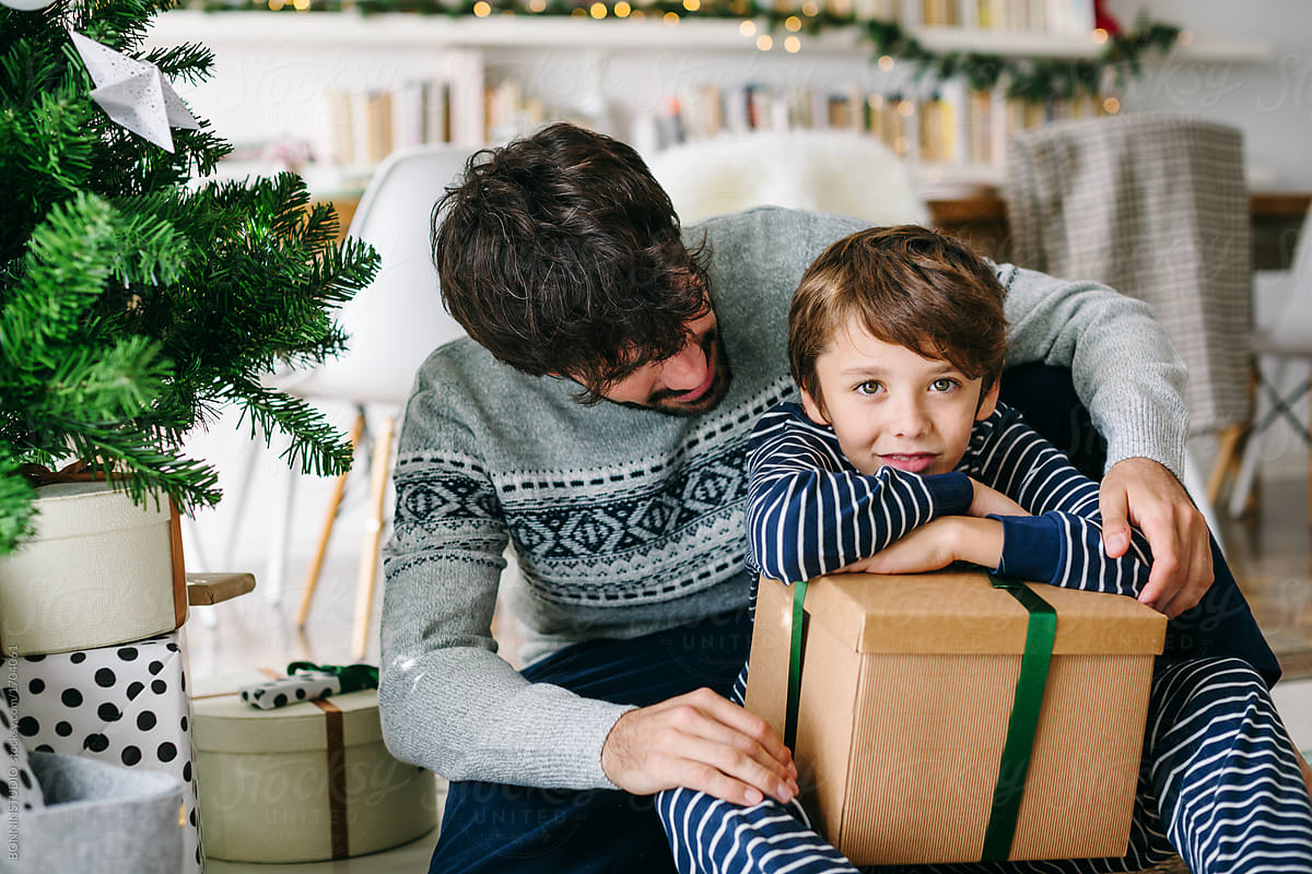 "Portrait Of Father And His Son Celebrating Christmas At Home." by ...