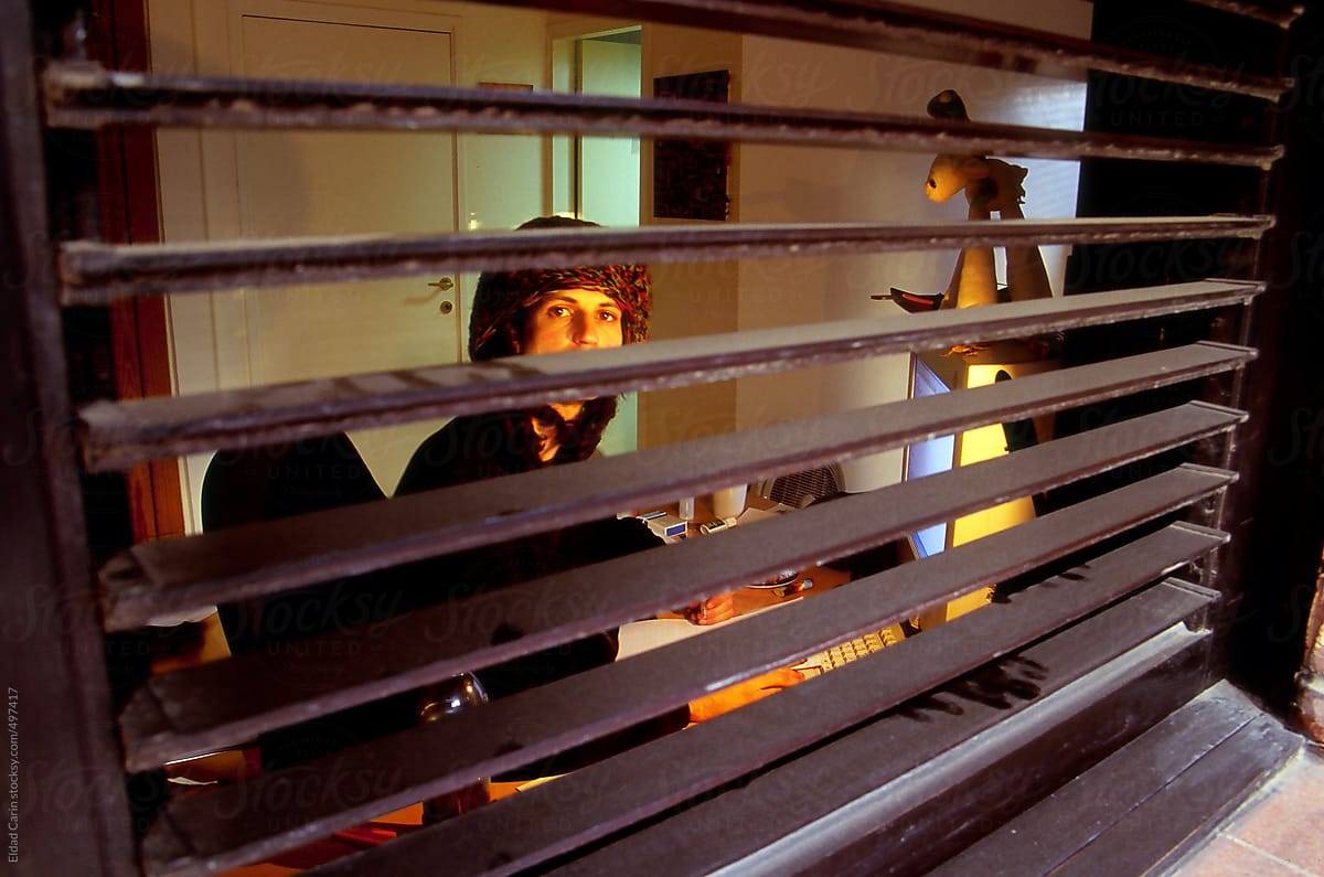 "Young Man At His Computer Through Blinds" by Stocksy Contributor ...