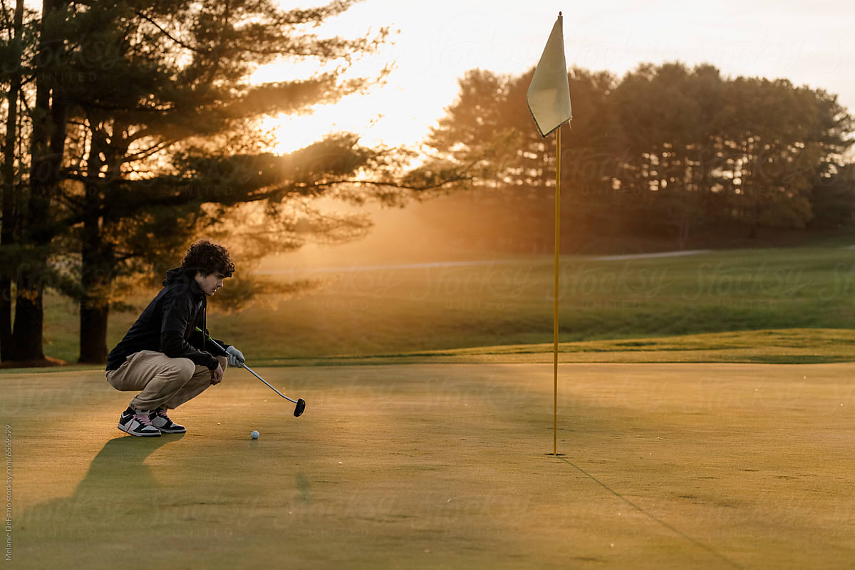 "Teenage Boy Golfing" by Stocksy Contributor "Melanie DeFazio" - Stocksy
