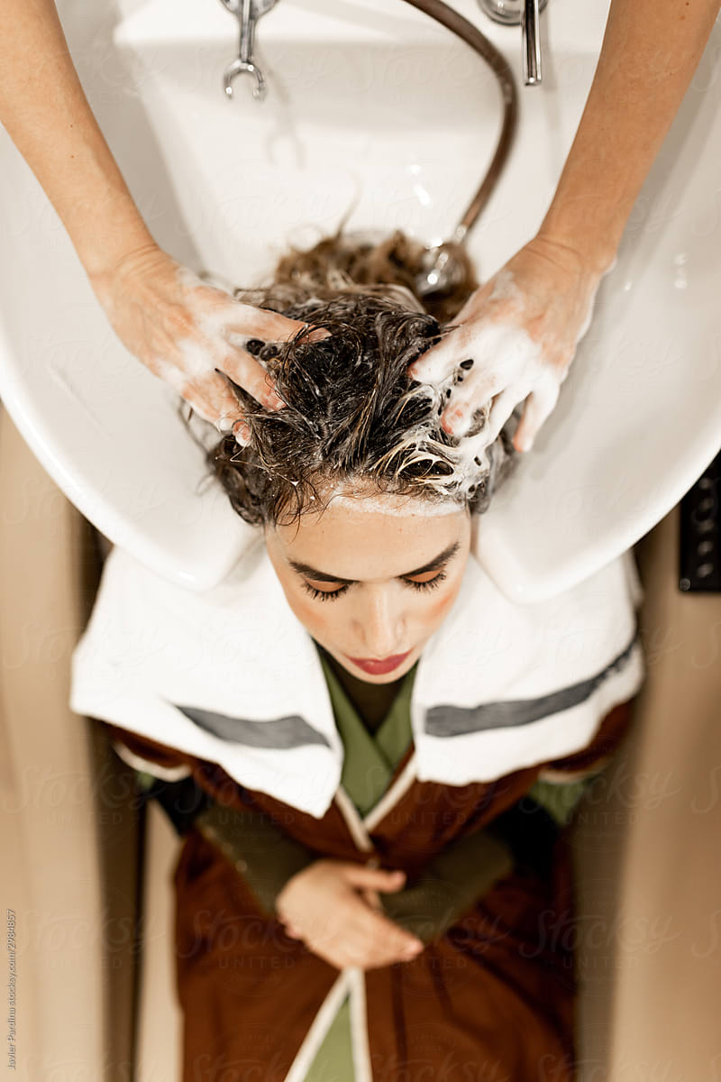 "Young Woman Washing Hair In Salon" by Stocksy Contributor "Javier ...