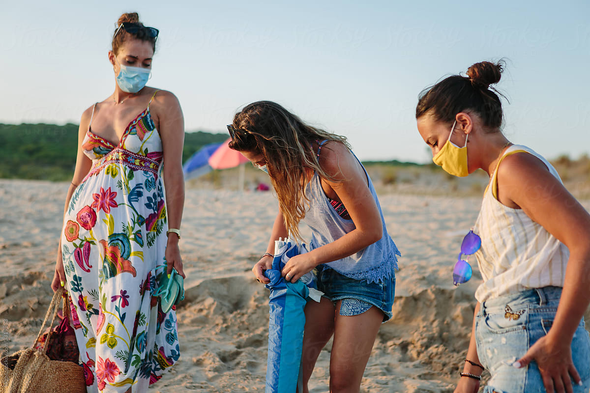 "Packing Up Beach Stuff" by Stocksy Contributor "Kkgas" - Stocksy