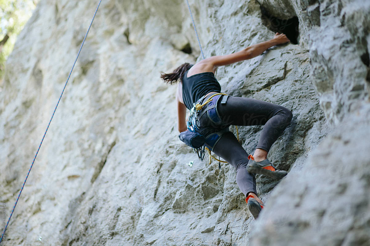 "Sportswoman Climbs Up A Steep Rock" by Stocksy Contributor "Marko ...
