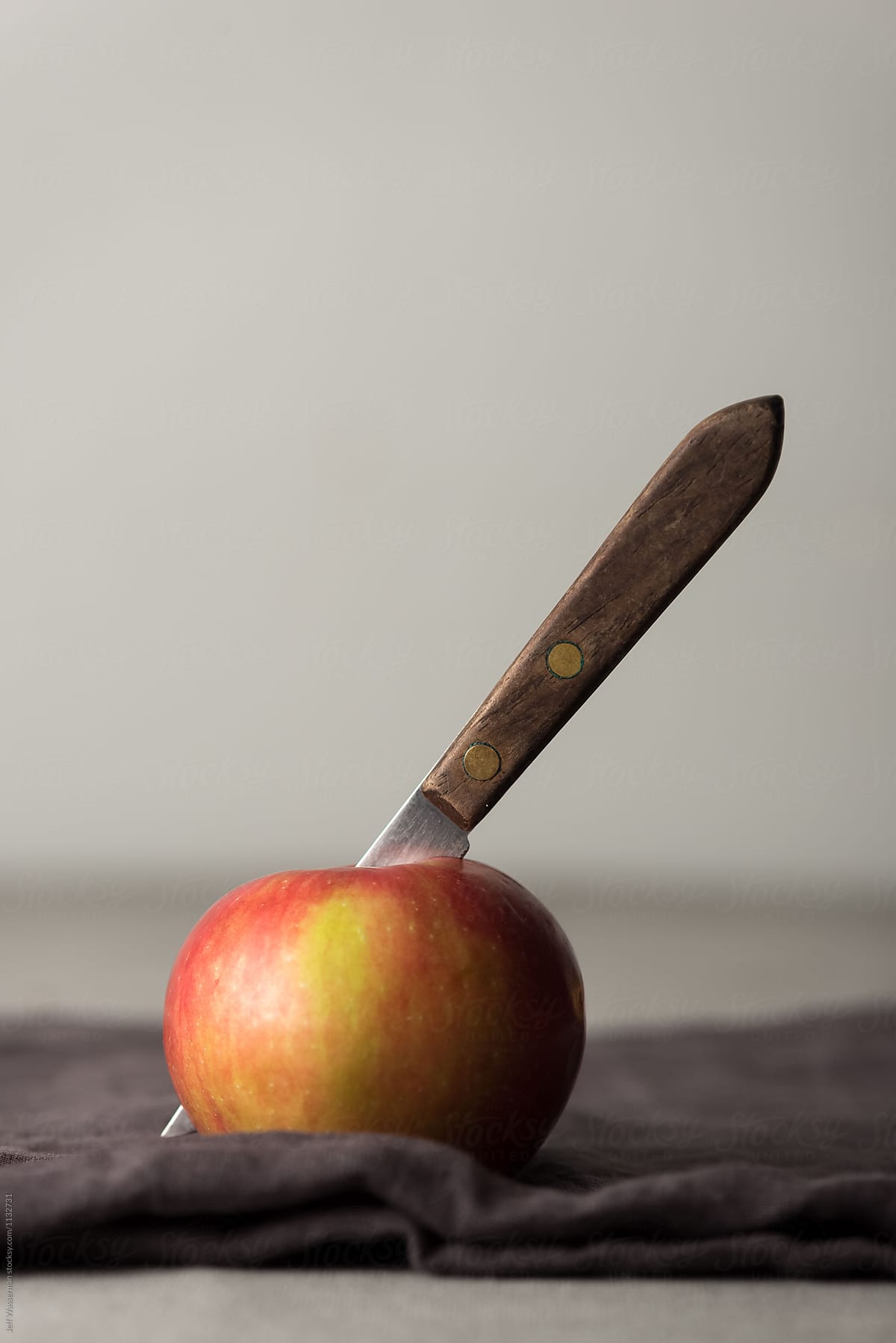"Apple With Knife" by Stocksy Contributor "Jeff Wasserman" - Stocksy