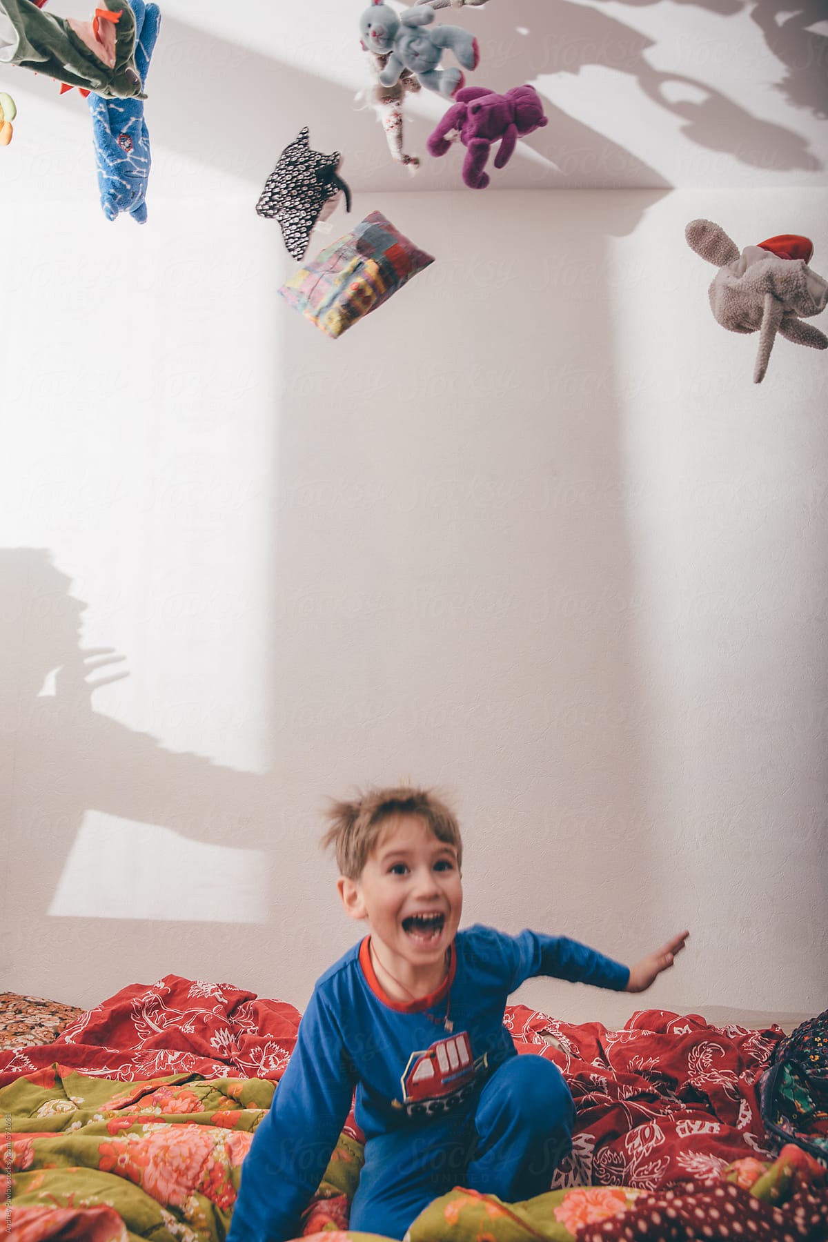 "Boy Scattering His Toys On The Bed" by Stocksy Contributor "Andrey ...
