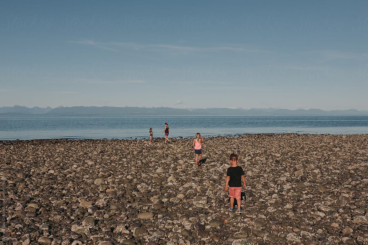 "Family Walking On Beach In Late Afternoon Sunshine" by Stocksy ...