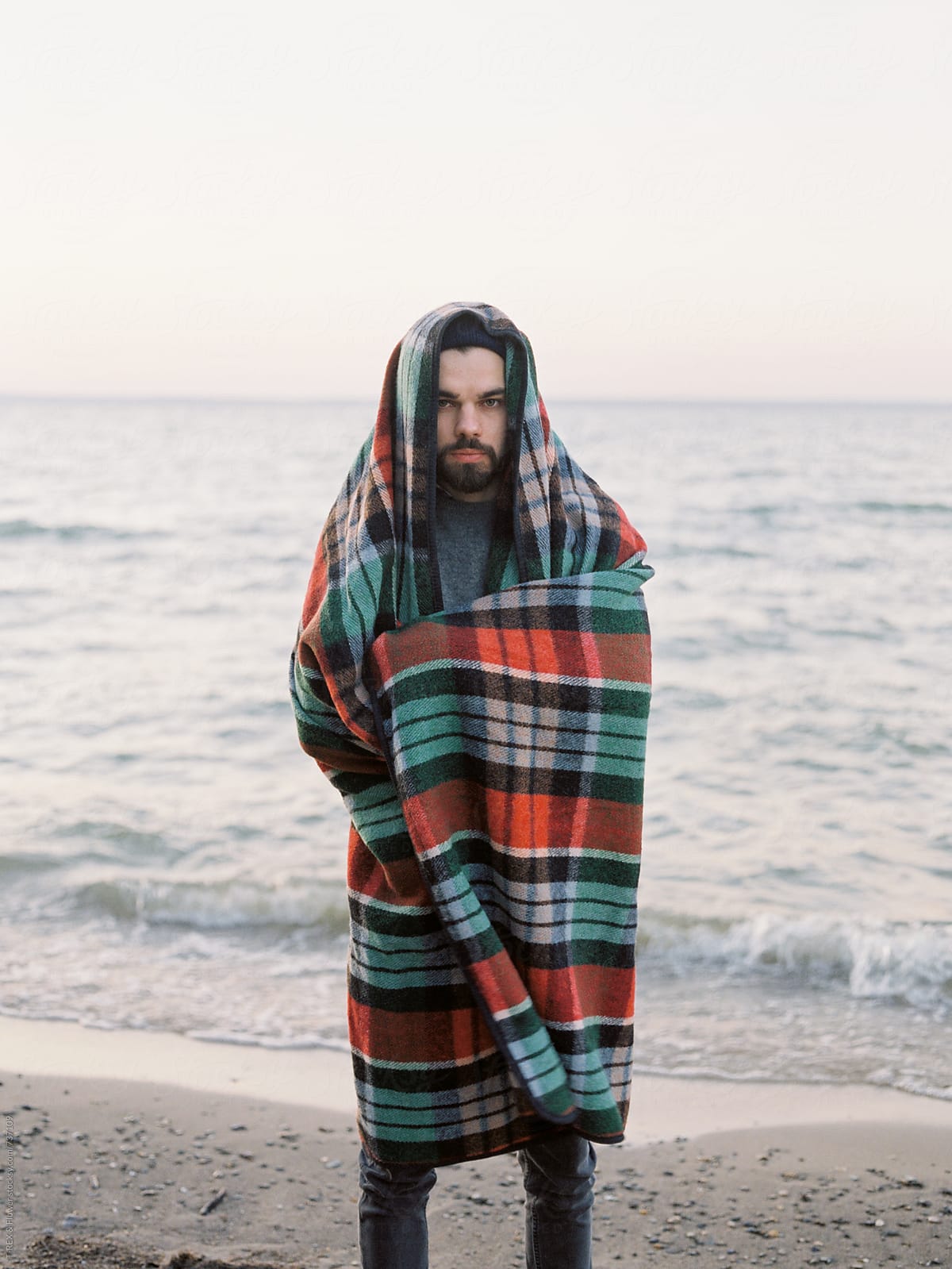 "Man Standing Wrapped" by Stocksy Contributor "Danil Nevsky" - Stocksy