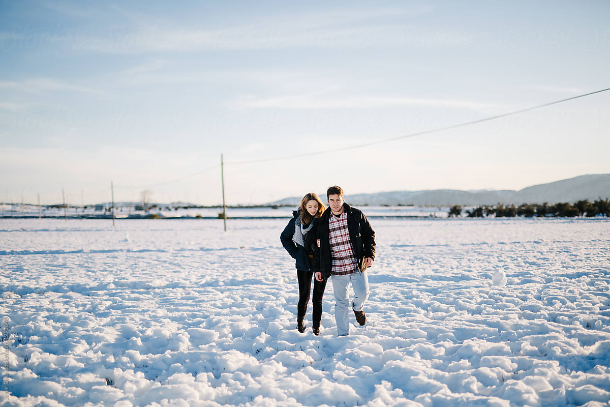 "Young Couple While Walk In Meadow" by Stocksy Contributor "Javier Díez ...