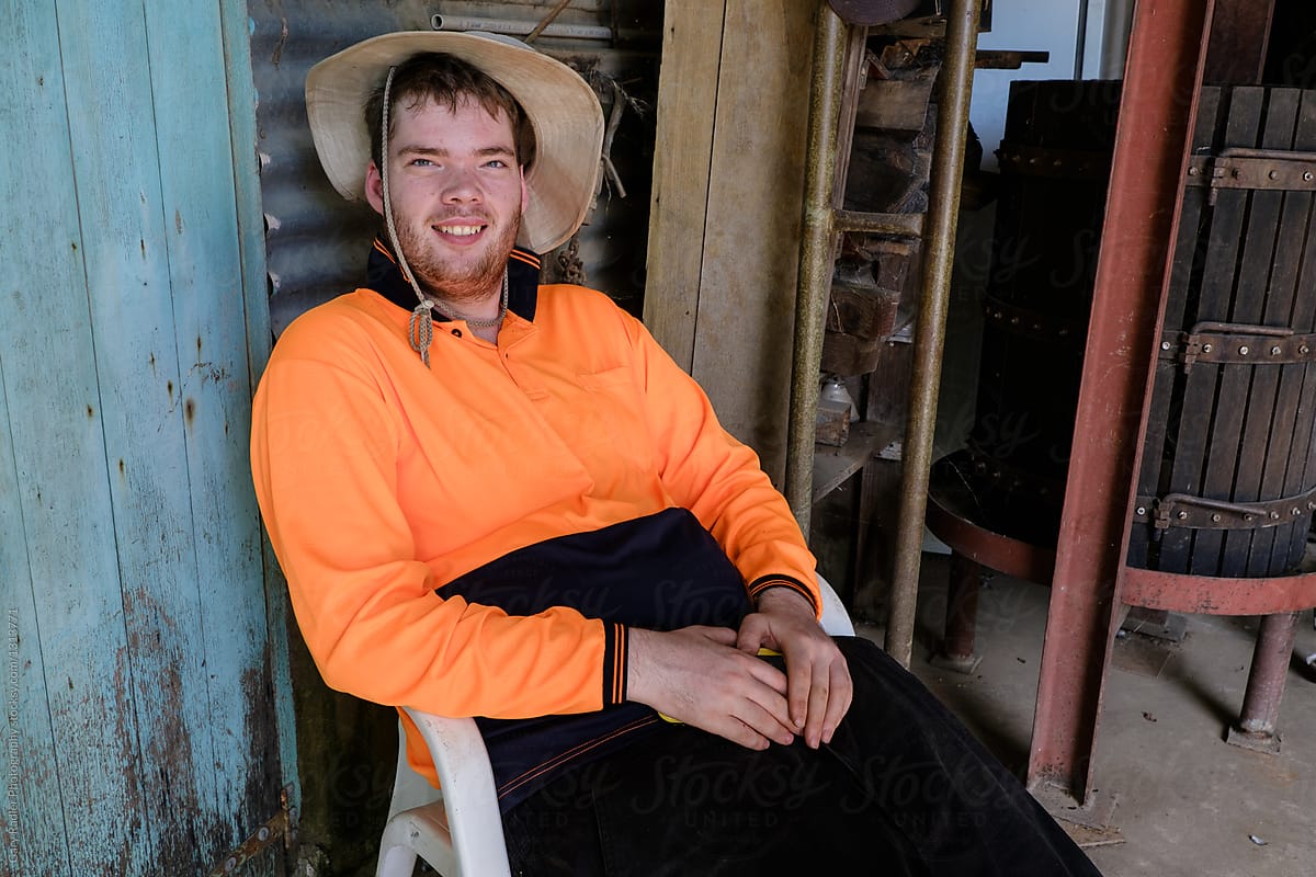 "Man In High Visibility Shirt Seated In A Farm Shed" by Stocksy ...