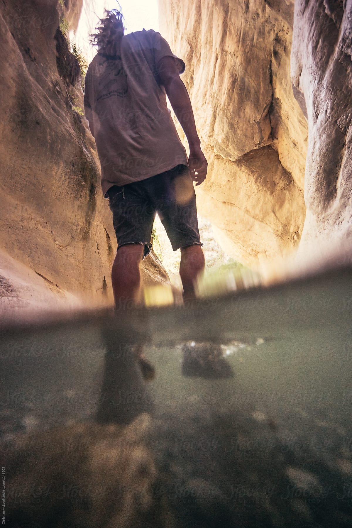 "Man Walks Through Water In A Gorge" by Stocksy Contributor "Ansel ...