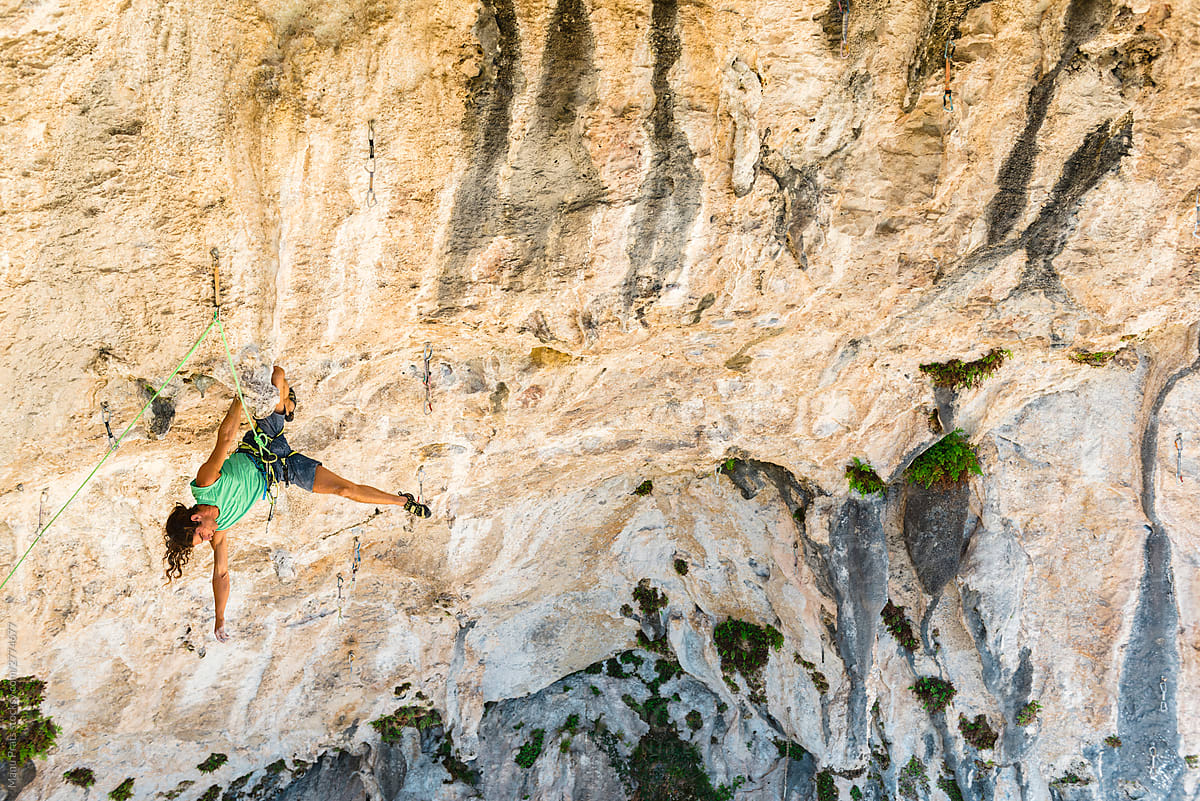 "Sporty Climber Climbing In A Cave" by Stocksy Contributor "Manu Prats ...