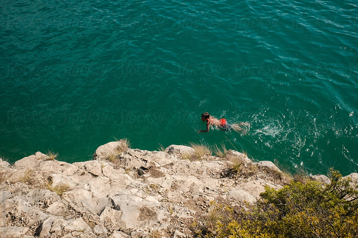"Little Boy Swimming In A Lake. View From Cliff." by Stocksy ...