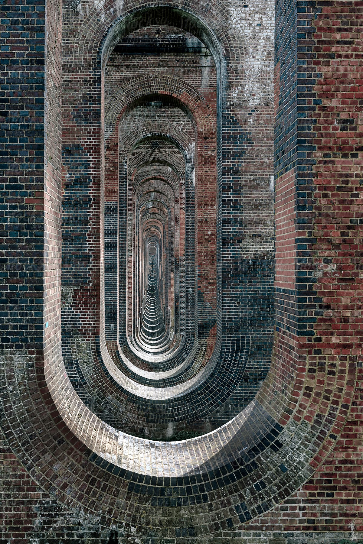 "Receding Interior Arched Columns Of A Railway Viaduct" by Stocksy ...