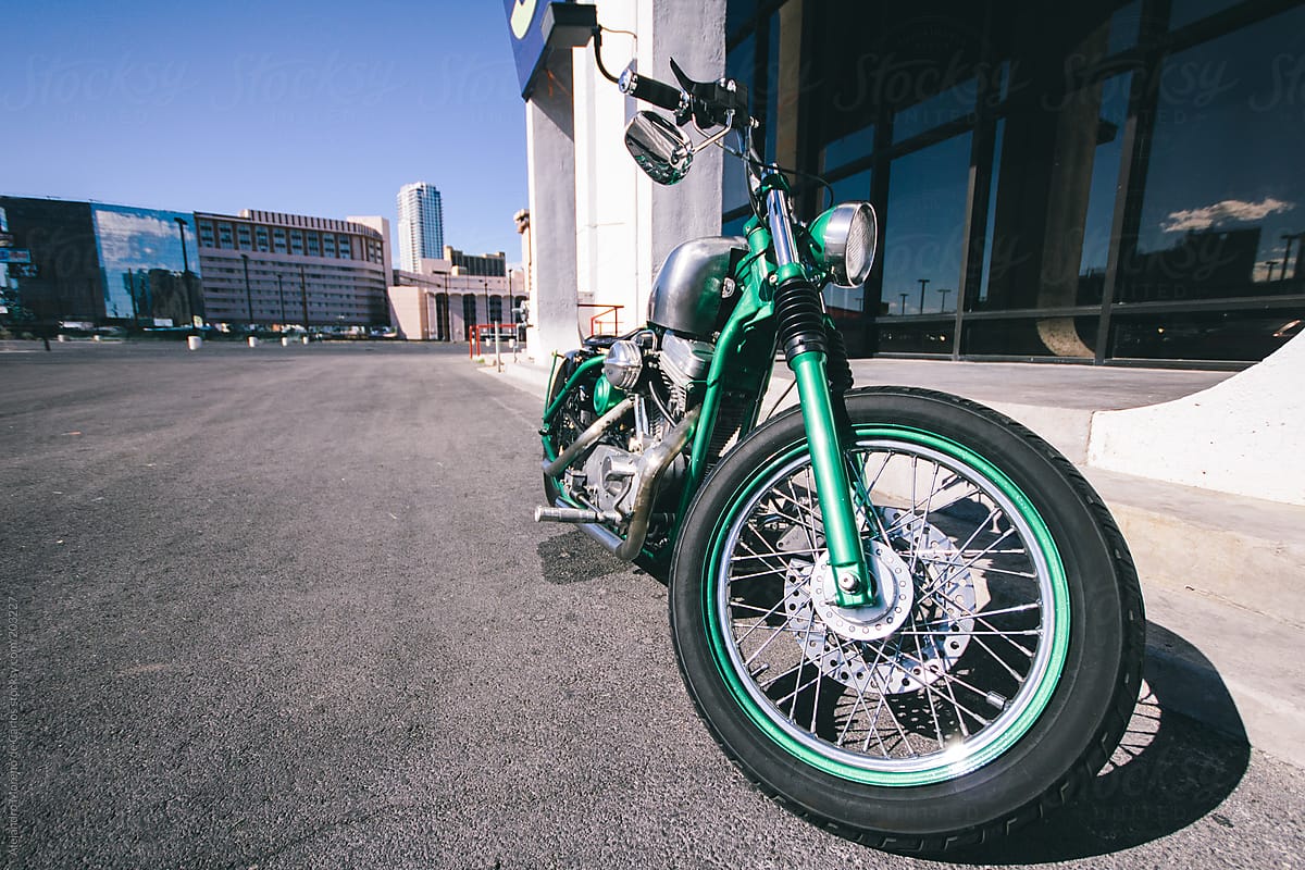 "Green Motorbike In A City Parking Lot" by Stocksy Contributor ...