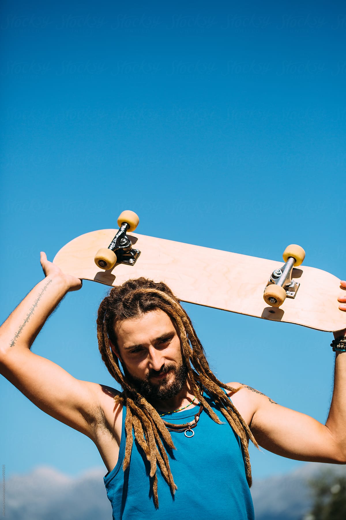 "Young Man Raising His Skateboard" by Stocksy Contributor "Michela ...