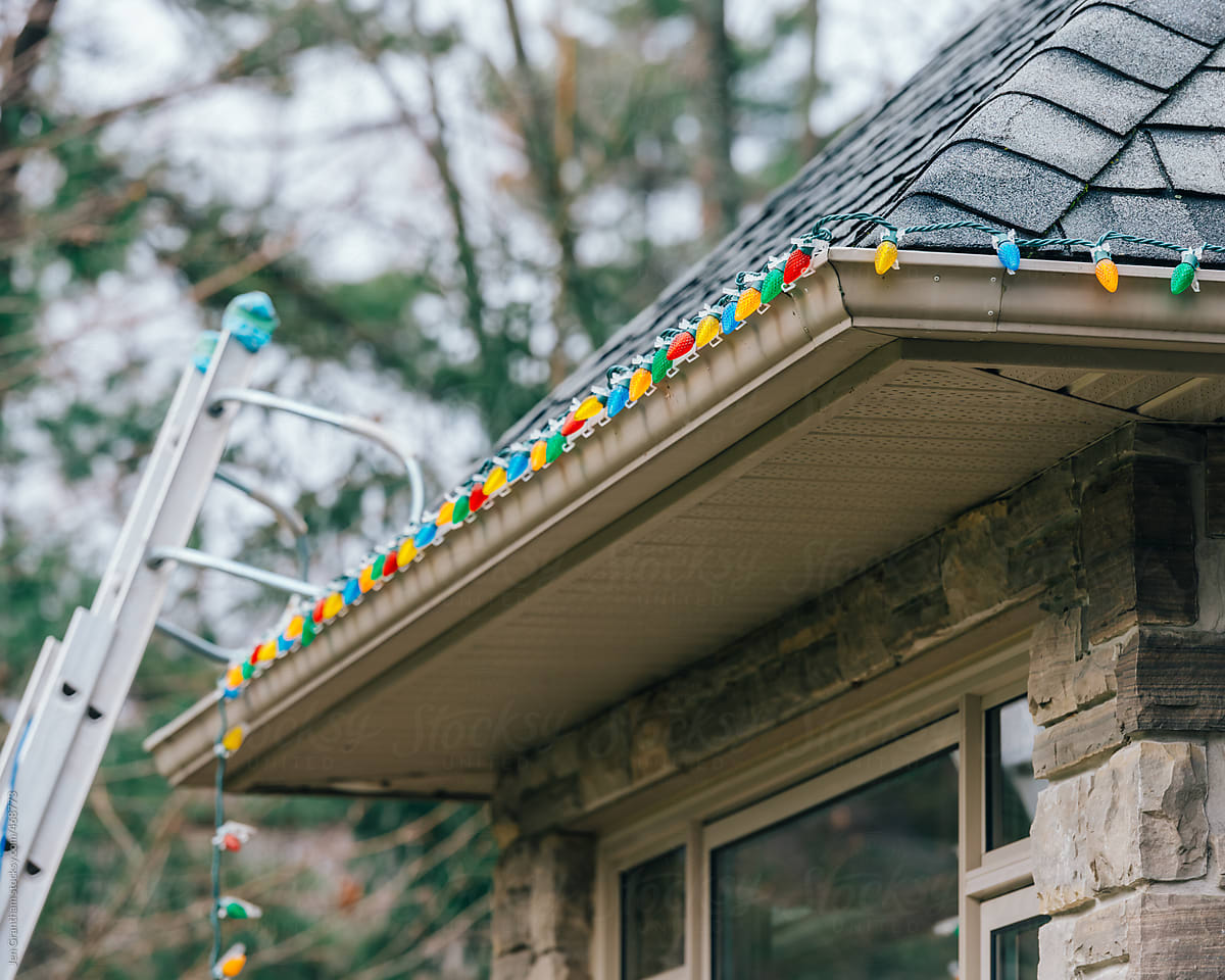 "Ladder Leaning Against Roof To Hang Christmas Lights" by Stocksy ...
