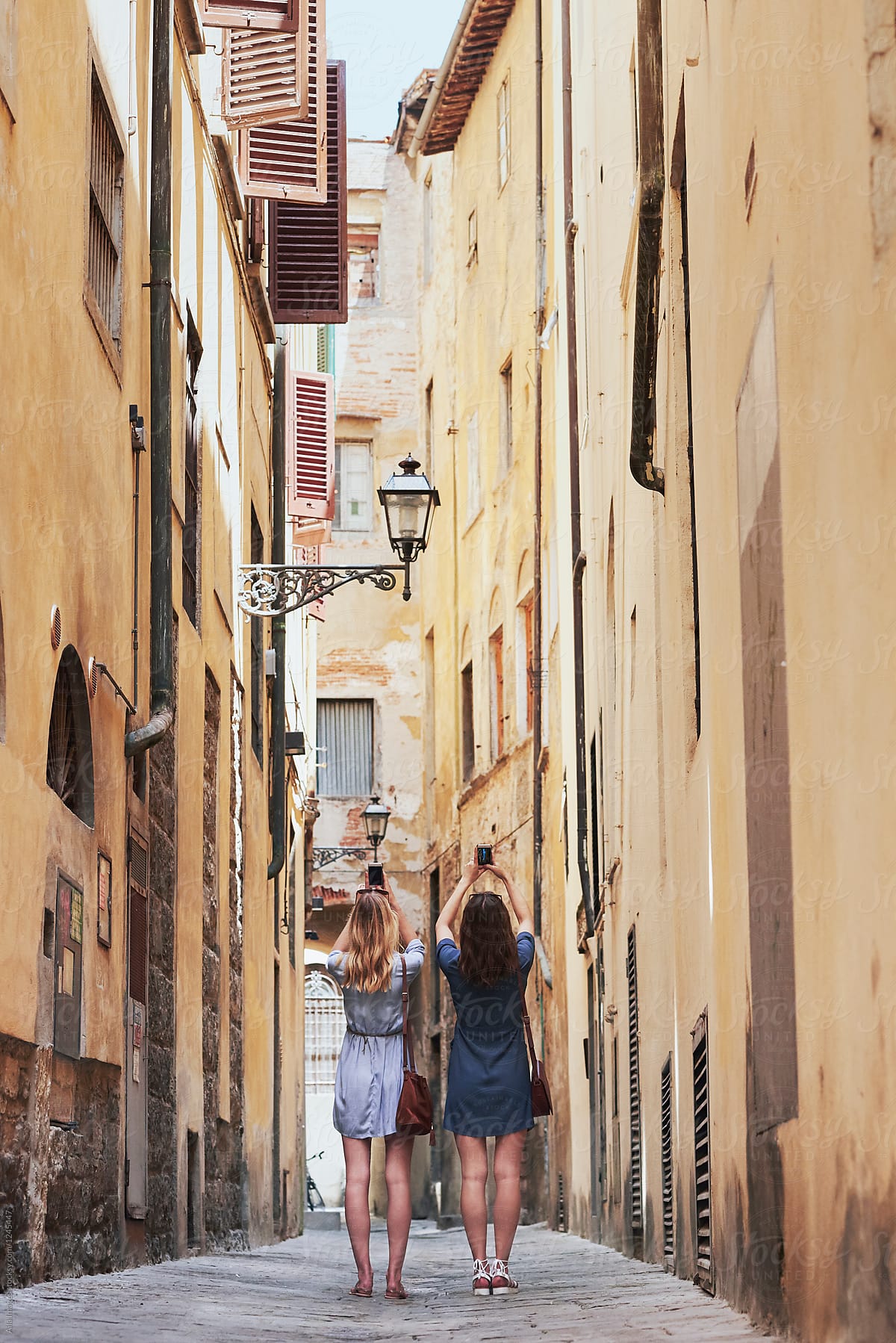 "Two Girl Friends Photograph Architecture Buildings With Smart Ph" by ...