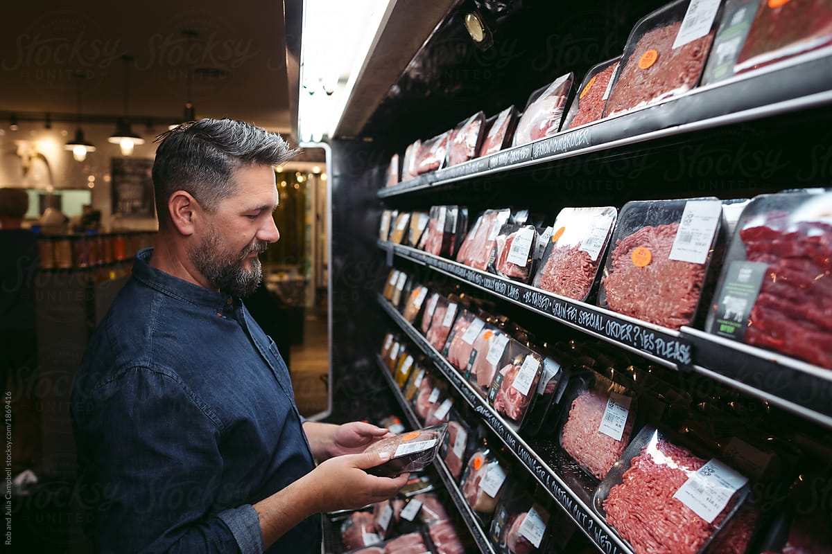 "Man Shopping For Meat In Grocery Store" by Stocksy Contributor "Rob ...