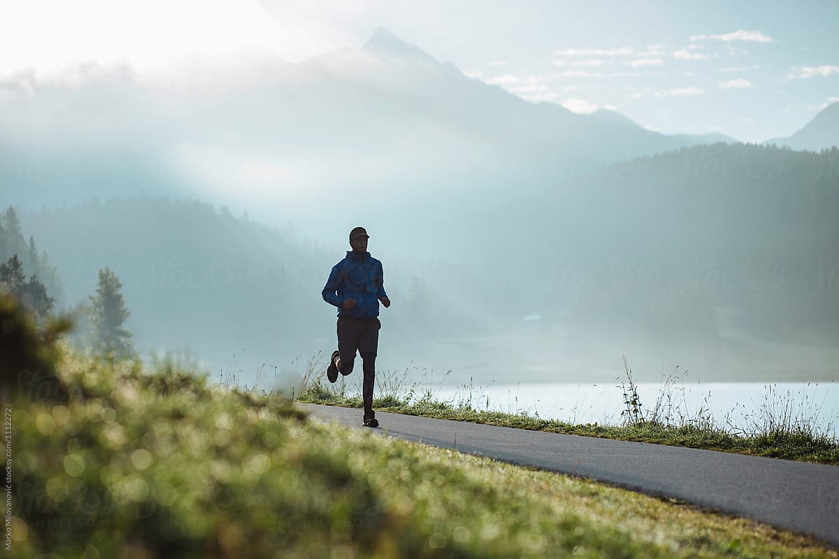 "Man Running Near The Lake" by Stocksy Contributor "Marko" - Stocksy
