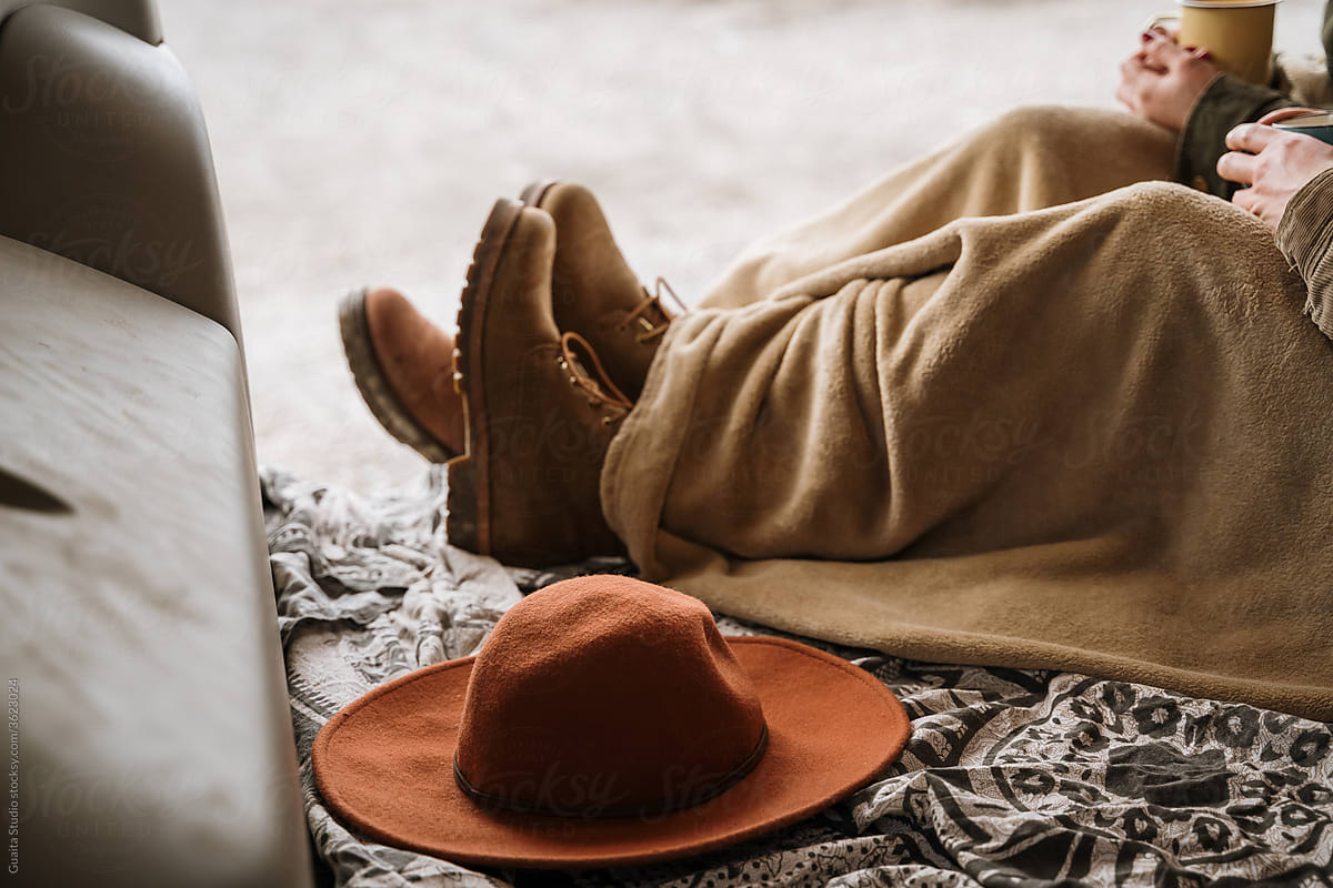 Detail Of Hat And Legs With Boots Inside Camper Van With Open Door By Detail Of Hat And Legs With Boots Inside Camper Van With Open Door By