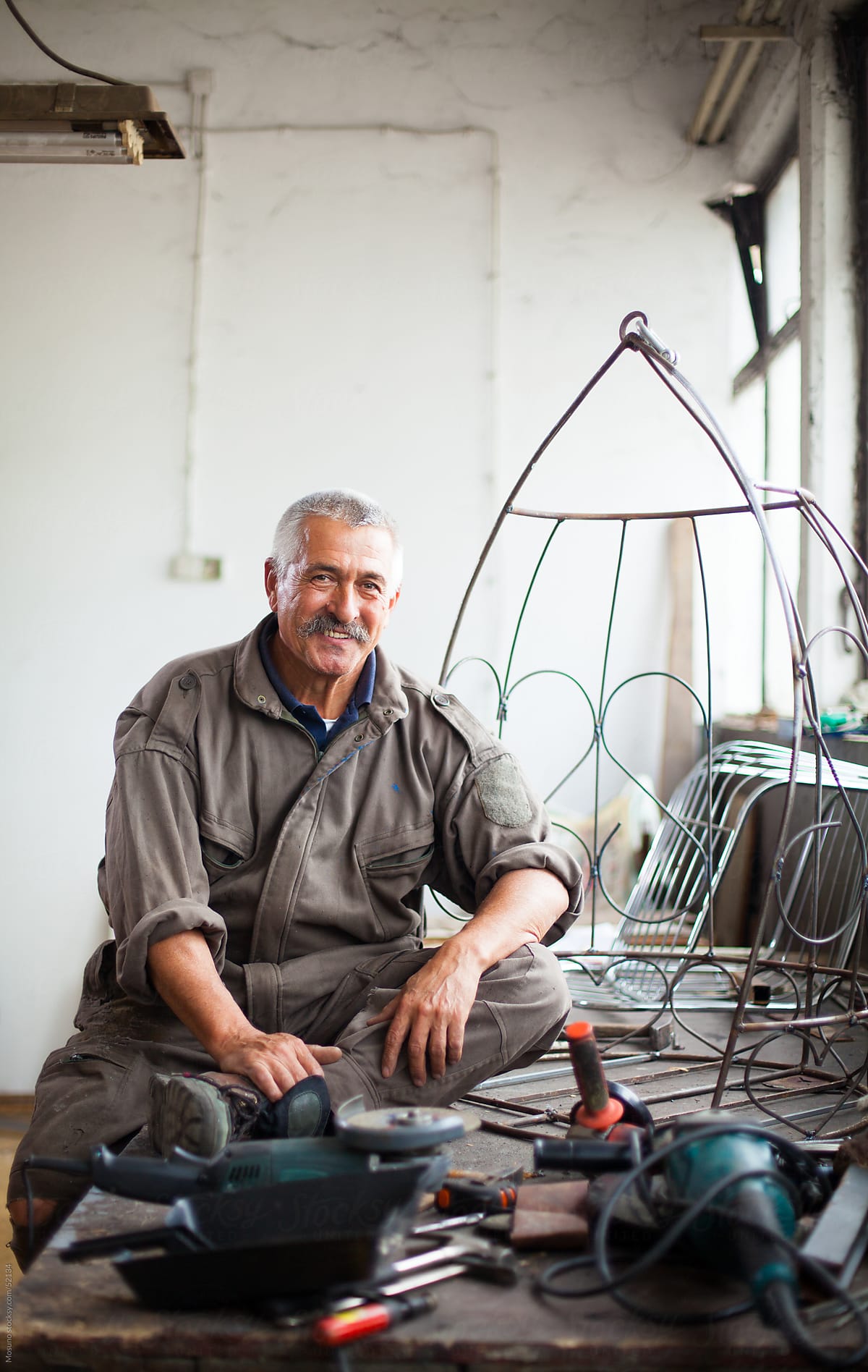 "Old Craftsman In His Workshop." by Stocksy Contributor "Mosuno" - Stocksy