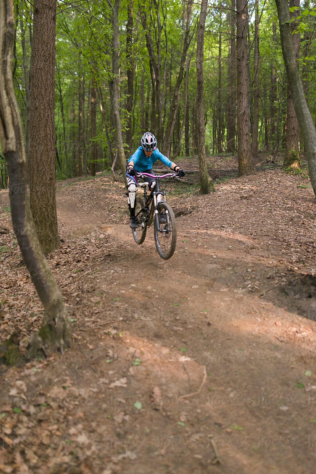 "Female Biker Doing Midair Tricks With Mtb Through Forest" by Stocksy ...