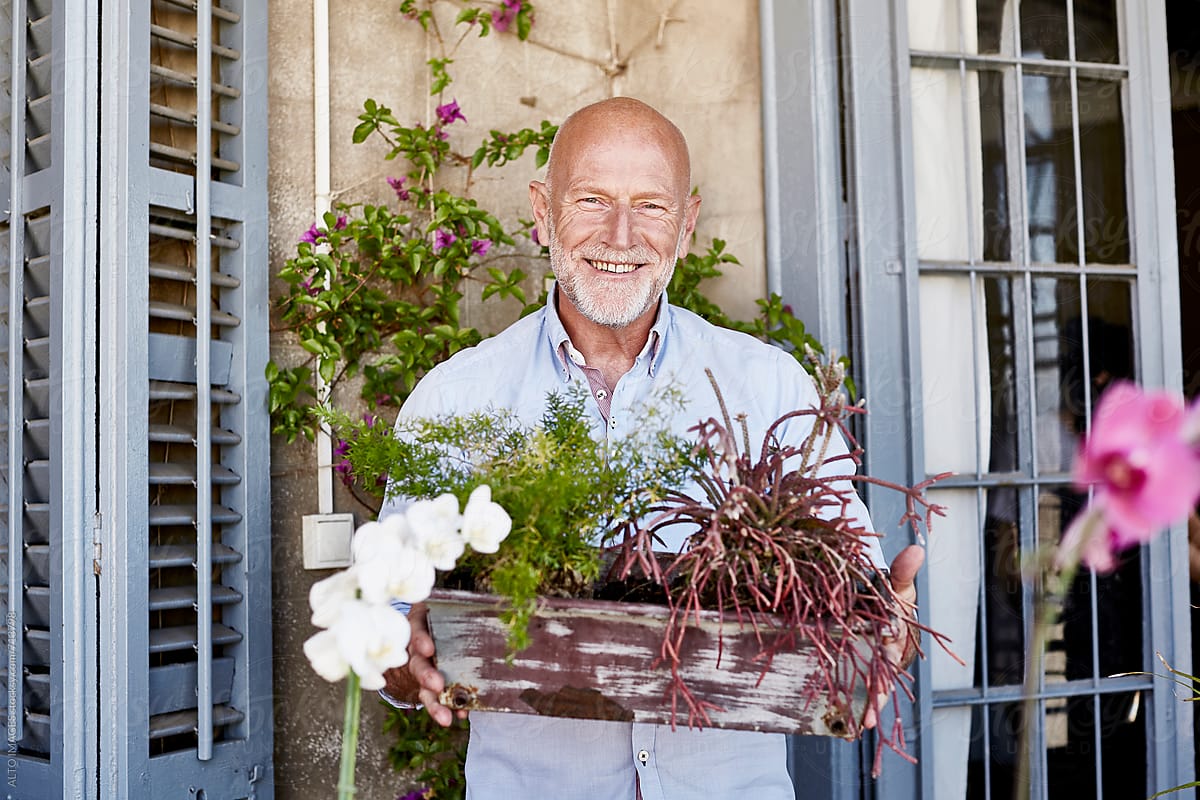 "Senior Man Carrying Pot Plants On Balcony" by Stocksy Contributor ...