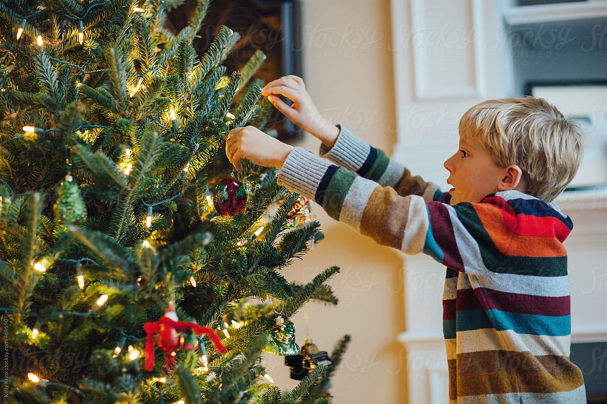 "Child Decorating A Christmas Tree" by Stocksy Contributor "Kelly Knox ...
