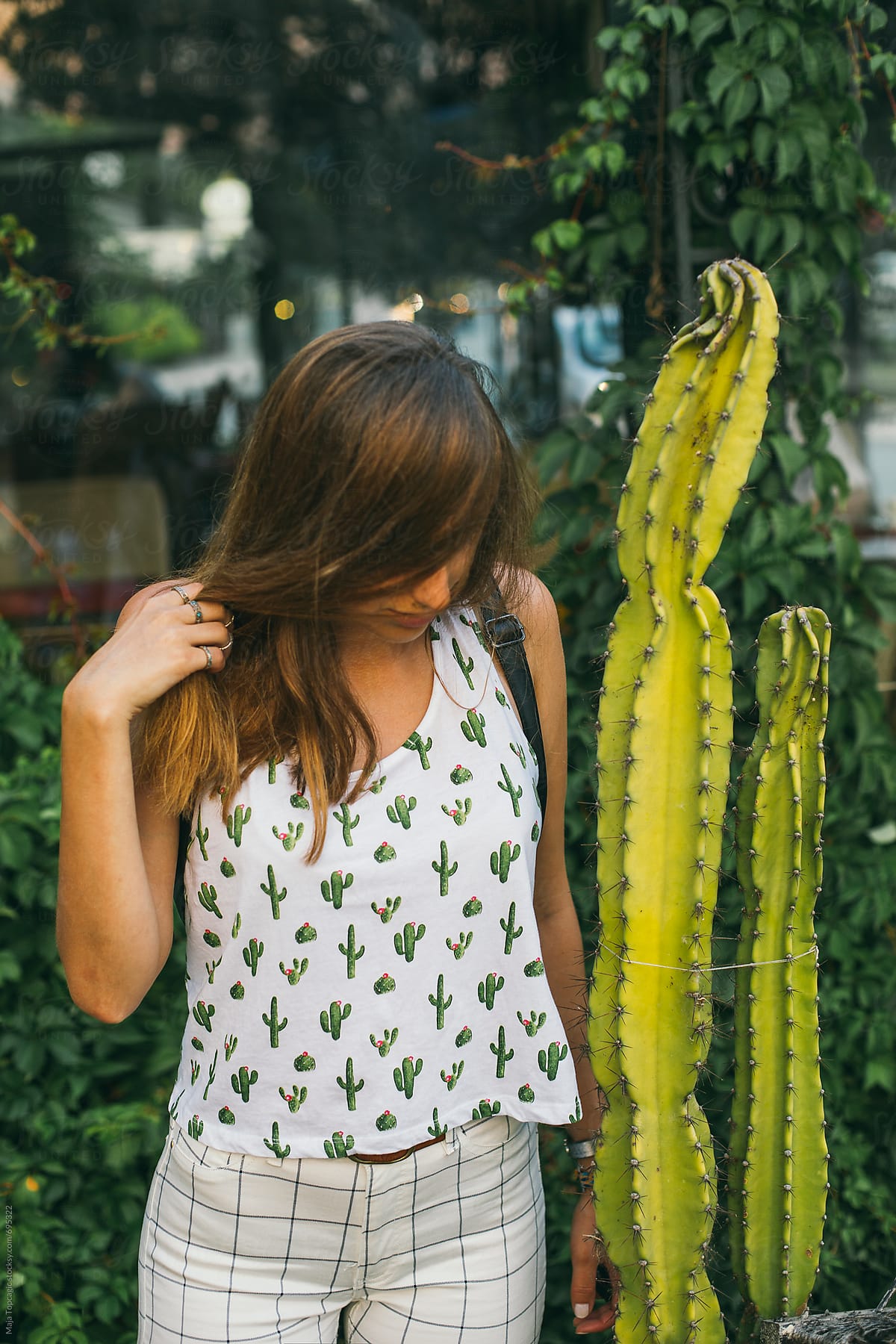 "Woman Wearing A Shirt With Cactus Print Near Cactus Plant" by Stocksy ...