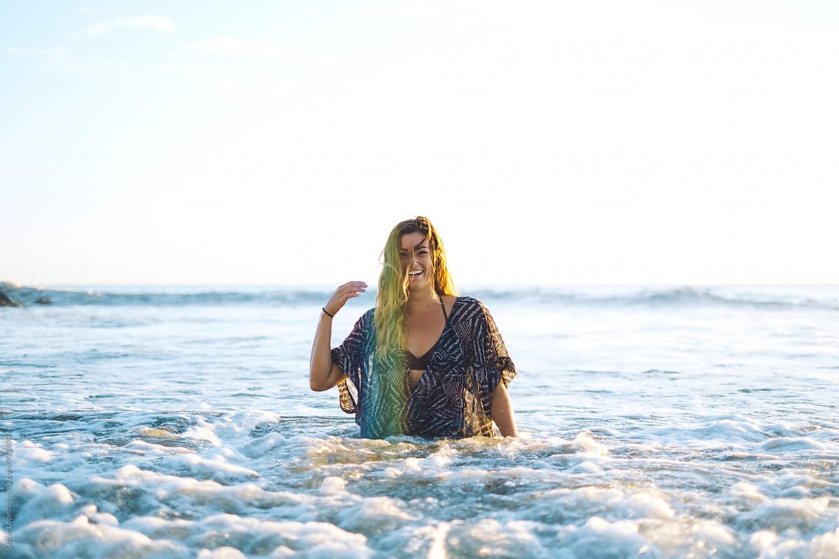 "Young Woman Laughing In The Sea" by Stocksy Contributor "Oscar Wolfie ...