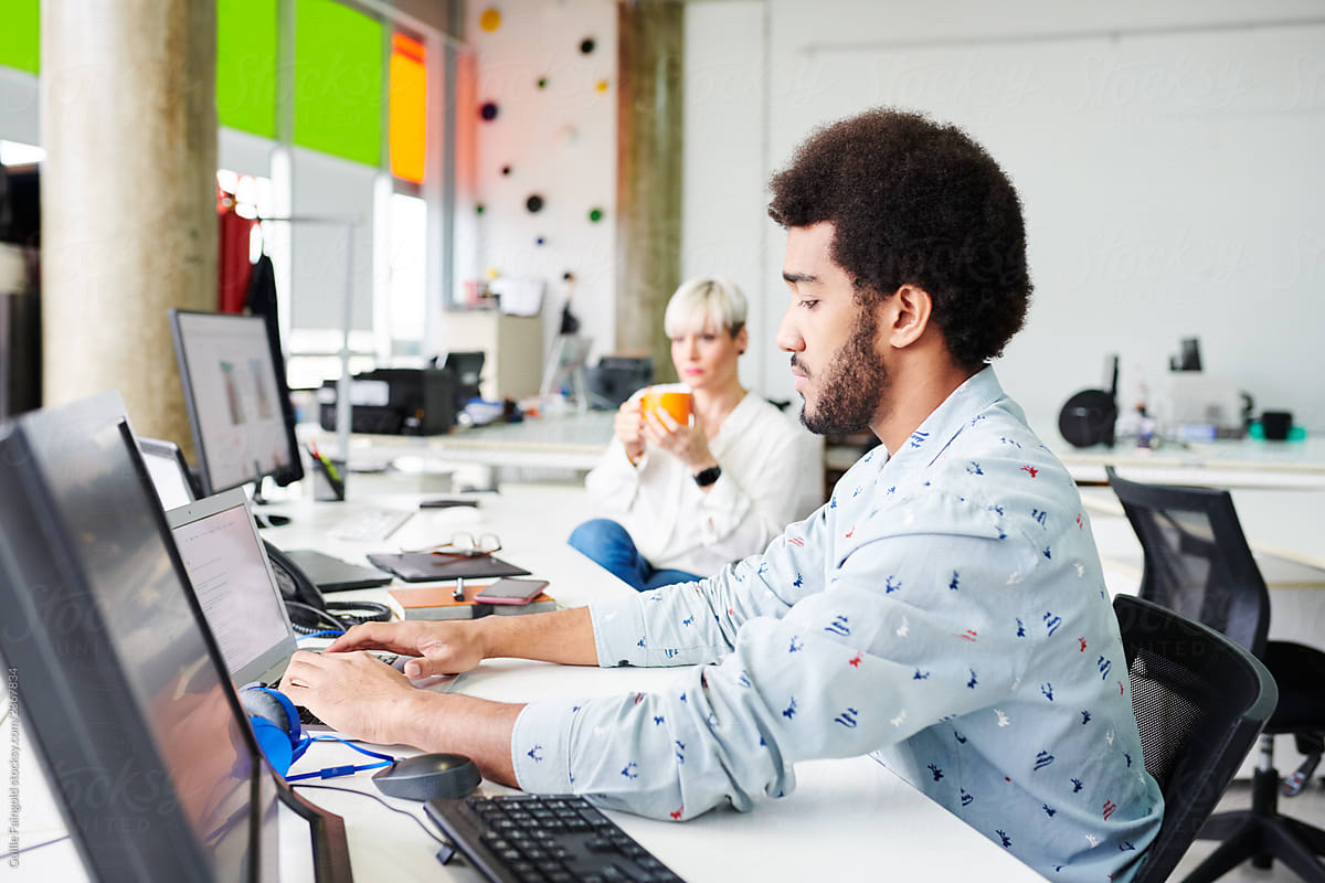 "People Working In Office At Long Desk" by Stocksy Contributor "Guille ...