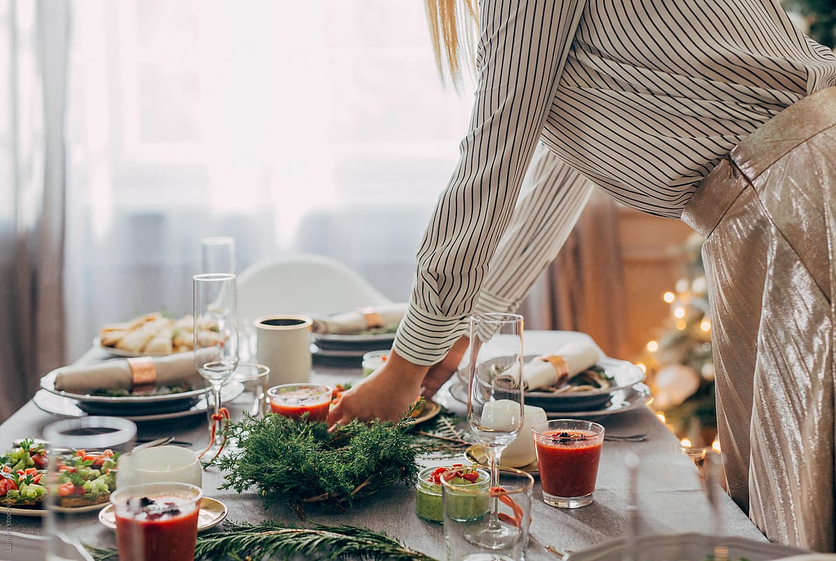 "Woman Putting A Dish On Decorated Table" by Stocksy Contributor ...