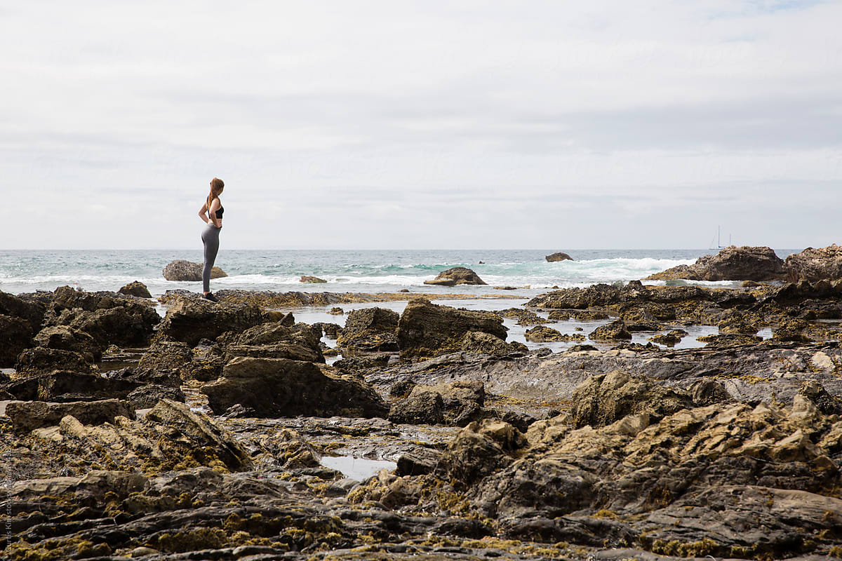 "Woman Standing On Rocks At The Beach" by Stocksy Contributor "Curtis ...