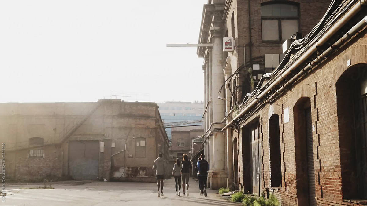  Group Of Athletes Running On The Street By Stocksy Contributor