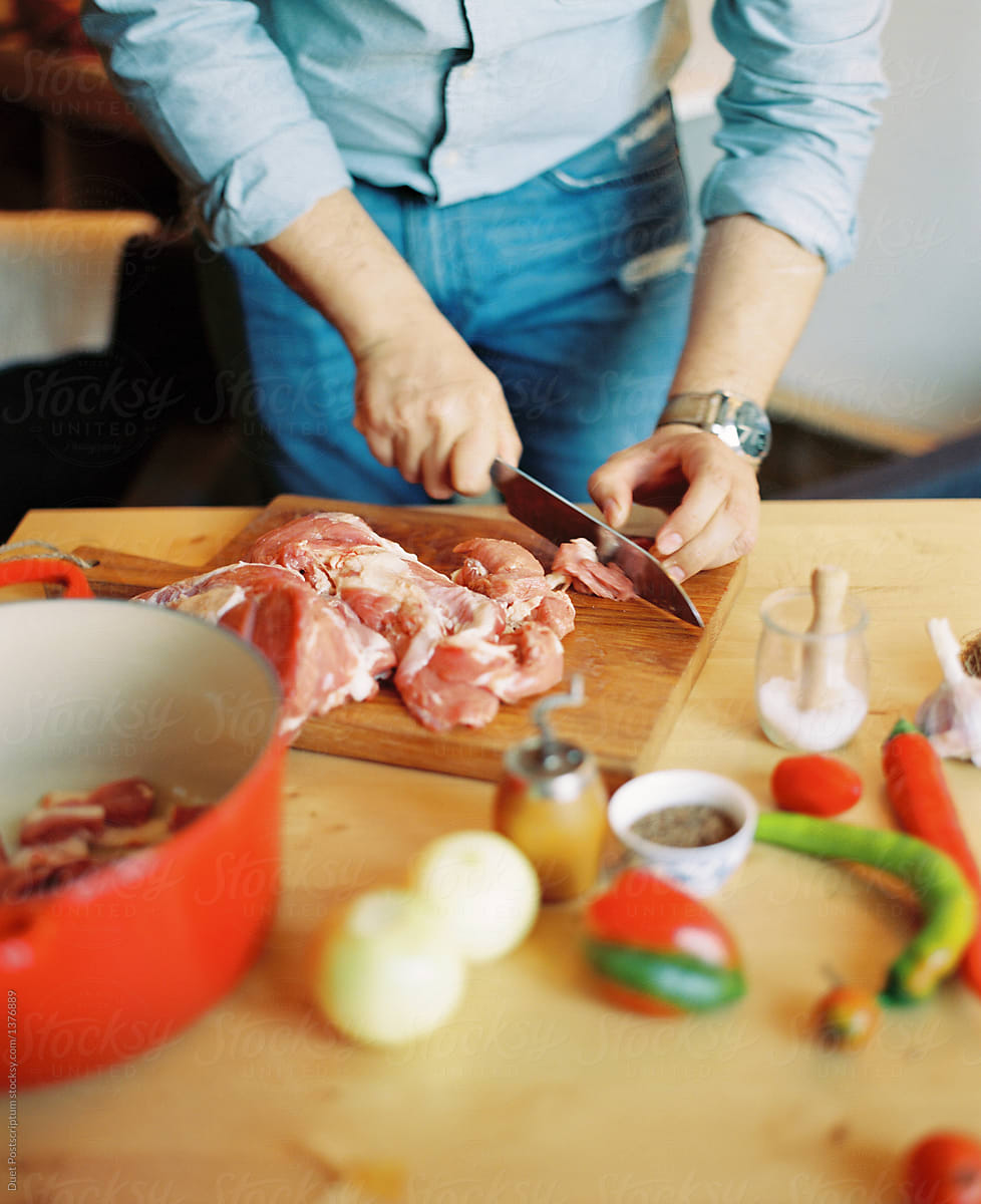 "Man Cutting The Meat" by Stocksy Contributor "Duet Postscriptum" - Stocksy