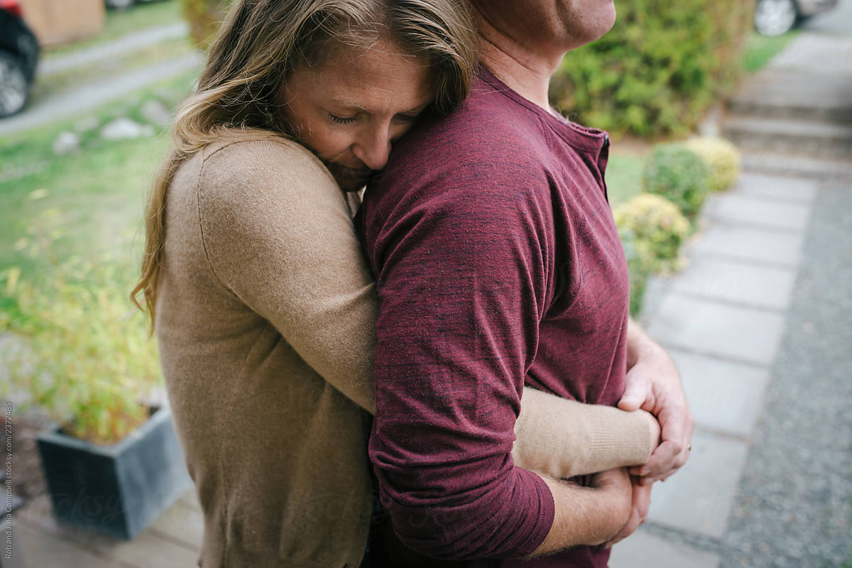 "Serious Couple Hugging Together At Home." by Stocksy Contributor "Rob ...