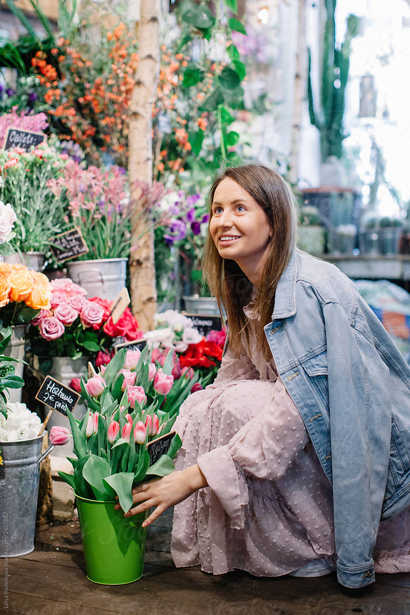 "Cheerful Smiling Woman At Flower Shop Among The Flowers" by Stocksy ...